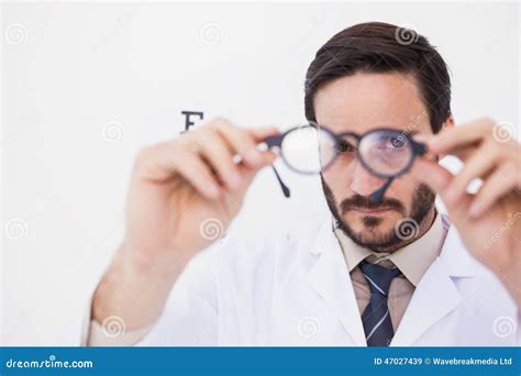 Doctor Wearing Lab Coat Looking Through Eyeglasses Stock Image Image