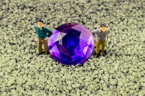 Premium Photo Tiny Figurine Of Man Miniature Model And Fake Diomond Gem
