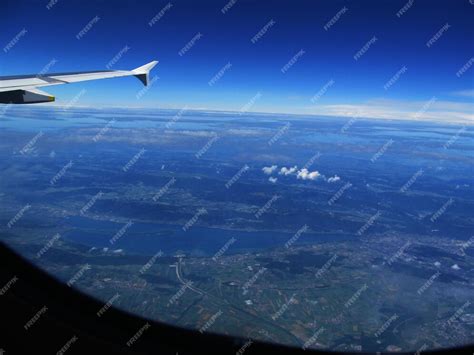 Premium Photo Cropped Image Of Airplane Wing Over Landscape