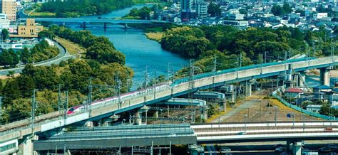 Tohoku Shinkansen Bullet Train Over The Kitakami River With Morioka