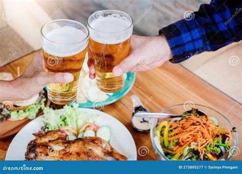 Young Asian Man Drinking Beer And Clink Glasses Happy While Enjoying