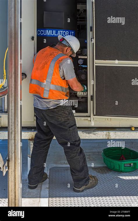 A Worker Working In The Compressor Panel Of A Co2 Cold Storage Industrial Refrigeration