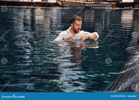 Enjoying The Swimming Man With Woman Is In The Pool Together Stock