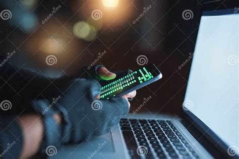 hackers arent afraid to your info an unrecognisable hacker using a cellphone and laptop in the