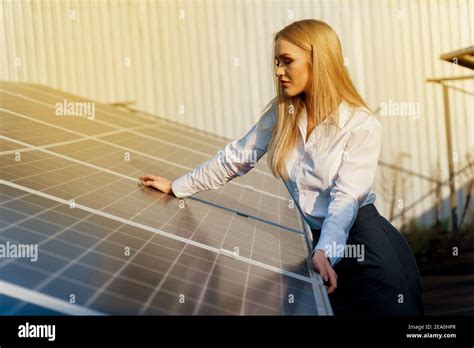 Woman Leans On Solar Panels Blonde Dressed White Formal Shirt On The Power Plant Free