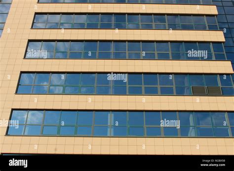 Modern Office Building Wall Made Of Blue Glass And Steel Frame