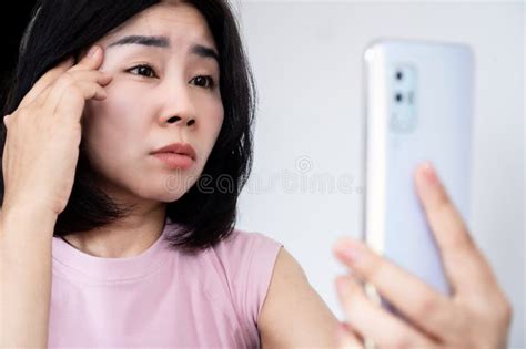 Asian Woman Have Problem With Blurry Eye To Read On Mobile Phone Screen