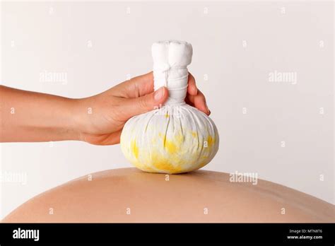 Thai Herbal Massage Stamp On Handsome Mans Back Isolated On White