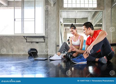 Women And Trainers Are Analyzing Exercise Young Woman With Personal Trainer And Exercise Plan