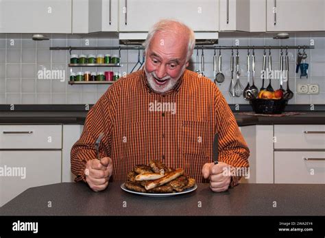 A Man Sits In The Kitchen Looking At His Wifes Delicious Meatballs