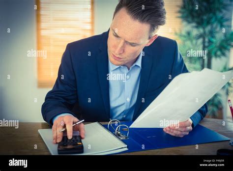 Concentrated Businessman Reading A Document Stock Photo Alamy
