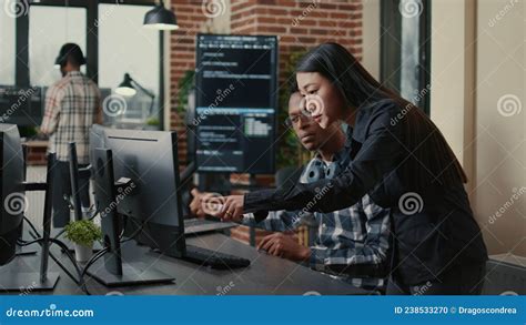 two programers holding laptop with coding interface walking towards