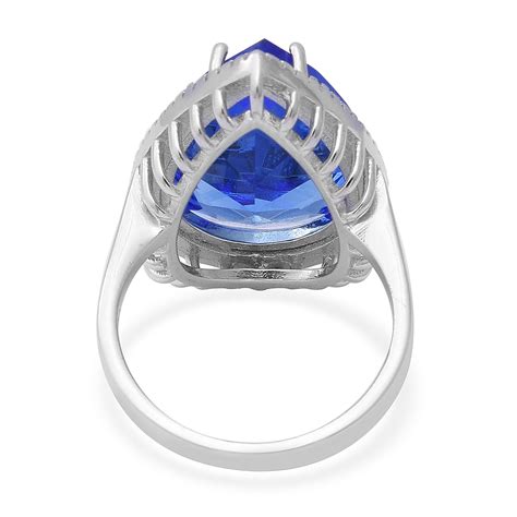 Elanza Simulated Tanzanite And Simulated Diamond Halo Ring In Rhodium