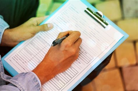Premium Photo Hand Of Person Writing In Clipboard