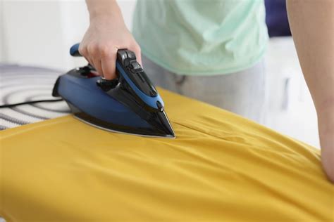 Premium Photo Housewife Irons Yellow Dress Using Hot Steam Appliance