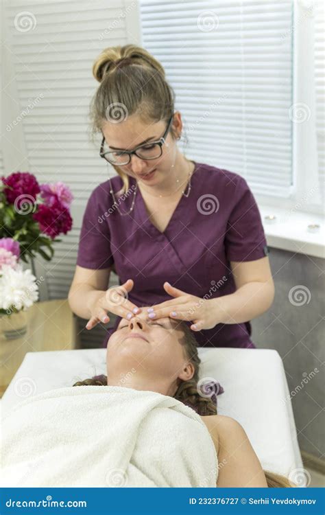Young Woman In Beauty Salon Relaxing Facial Massage For Beauty And