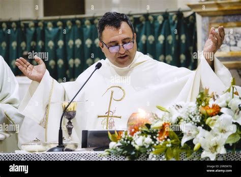 A White Caucasian Catholic Priest Delivering Eucharistic Prayer During
