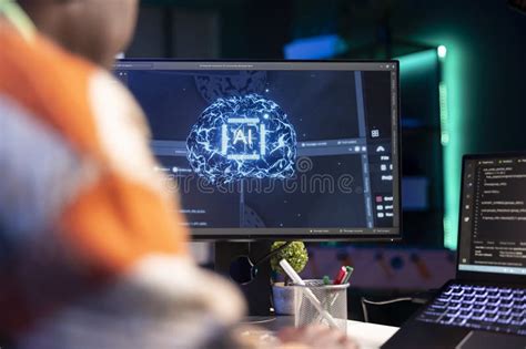 professional male developer manages neural network at desk stock image