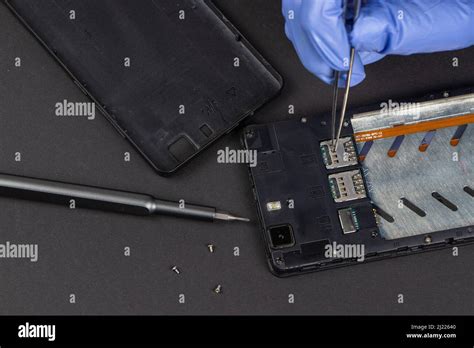 Process Of Mobile Phone Repair Hands Of A Service Worker Repairing Modern Mobile Phone Stock