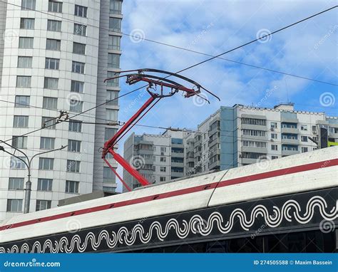 Tram Pantograph On The Background Of The Sky And A Residential Building
