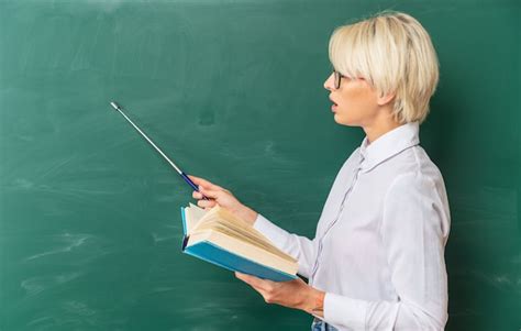Free Photo Impressed Young Blonde Female Teacher Wearing Glasses In