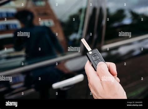 Hand Of Man Unlocking Car Using Key Stock Photo Alamy