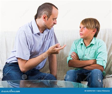 Father And Son Seriously Talking At Home Stock Photo Image Of