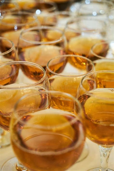 Wine Glasses And Orange Juice Glass On A White Table Background Stock