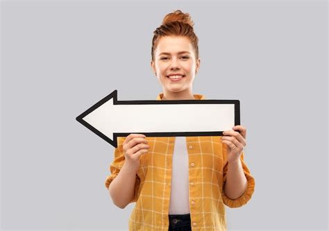 Premium Photo Red Haired Teenage Girl With Arrow Showing To Left