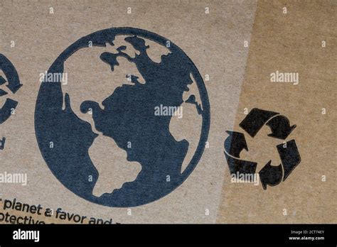 Mobius Loop Symbol And Earth Globe Detail On Recyclable Corrugated Cardboard Box Disposal