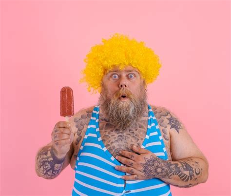 Premium Photo Fat Amazed Man With Beard And Wig Eats A Popsicle