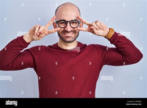Young Bald Man With Beard Standing Over White Background Wearing