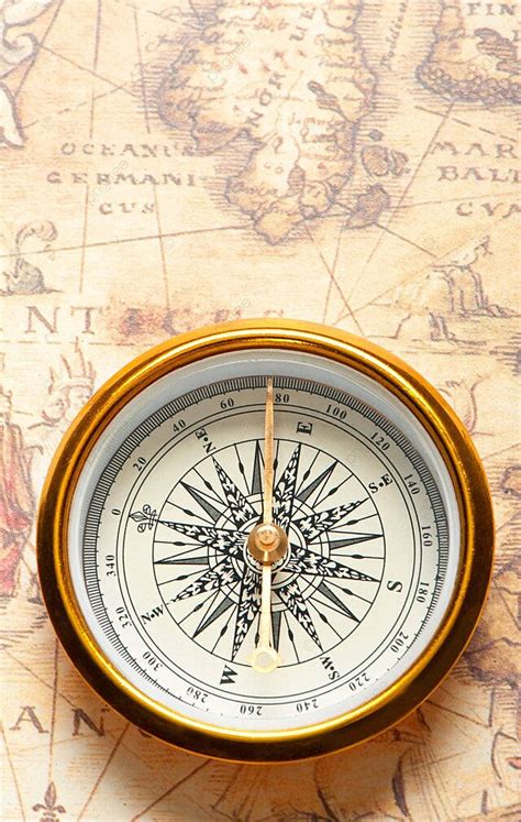 Old Compass On Ancient Map West Obsolete Copper Photo Background And