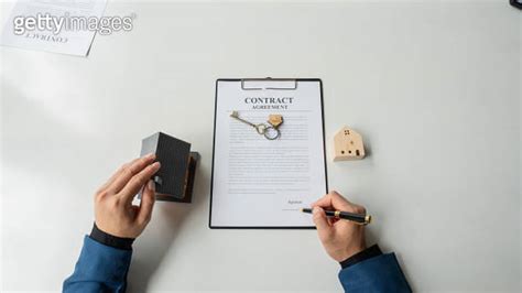 Real Estate Agent With Wooden House Example And Top View Calculator Employees Offer Contracts