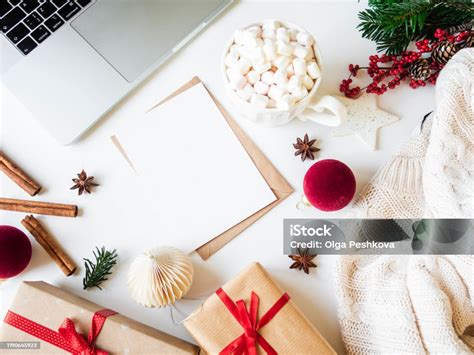 크리스마스 장식이있는 홈 오피스 책상 봉투가있는 엽서 마시멜로가있는 뜨거운 음료가있는 컵 선물 니트 풀오버 및 향신료 맨 위 보기 모형에 대한 스톡 사진 및 기타 이미지