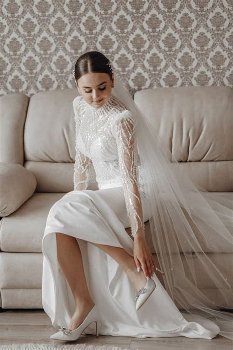 The Bride In Her Wedding Dress Poses In Her Room Stock Photo Image Of Body Gown