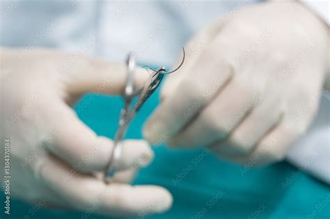 Doctor Hand Wear Sterile Gloves And Surgery Scissor Stitching Up Wound