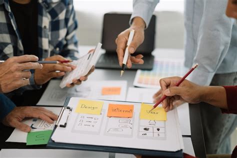 Premium Photo Ui Designer Brainstorming About Mobile App Interface Wireframe Design With