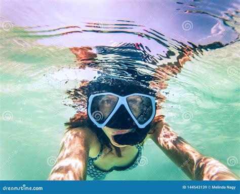 Woman Taking An Underwater Selfie While Snorkeling In Crystal Clear