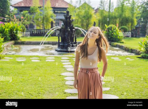 Young Woman Tourist In Traditional Balinese Hindu Temple Taman Ayun In