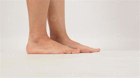 Asian Woman Is Standing With Legs And Barefoot On White Background