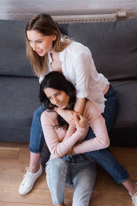 Cheerful Lesbians Hugging And Looking At Stock Image Image Of Home