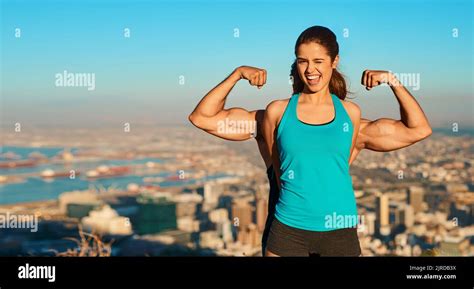 Showing Off Her Guns Cropped Portrait Of A Young Woman Standing In