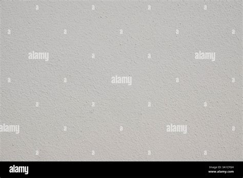 A White Wall With A Rough Texture The Wall Is Covered In Small Bumps