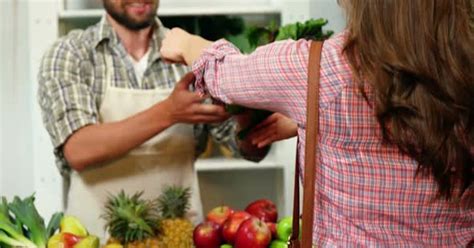 Woman Purchasing Leafy Vegetable From Male Staff Stock Video Envato