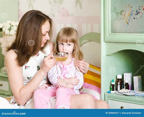 Mother Gives Her Daughter A Medicinal Drink With A Fizzy Tablet Royalty