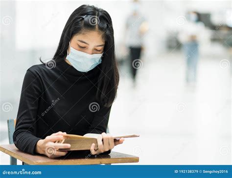 Portrait Of A Teenager College Student Wears Face Mask While Reading