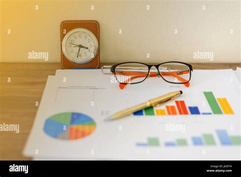 Business Concept Of Office Working And Analysis Graphics And Clock On