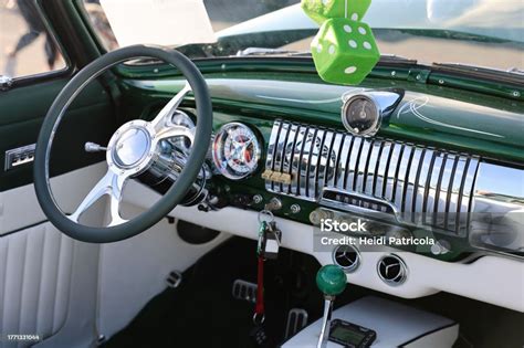 Vintage Dashboard Of A 1950s Sedan With Green Fuzzy Dice Hanging From