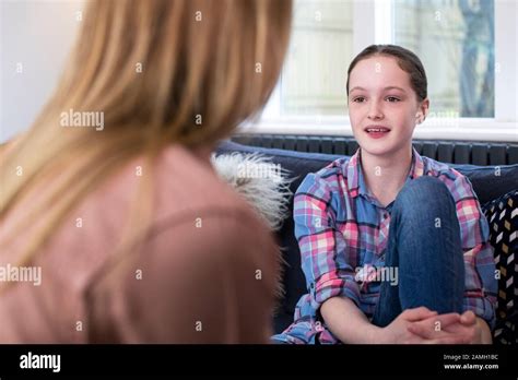 Mother Having Serious Conversation With Young Daughter At Home Stock